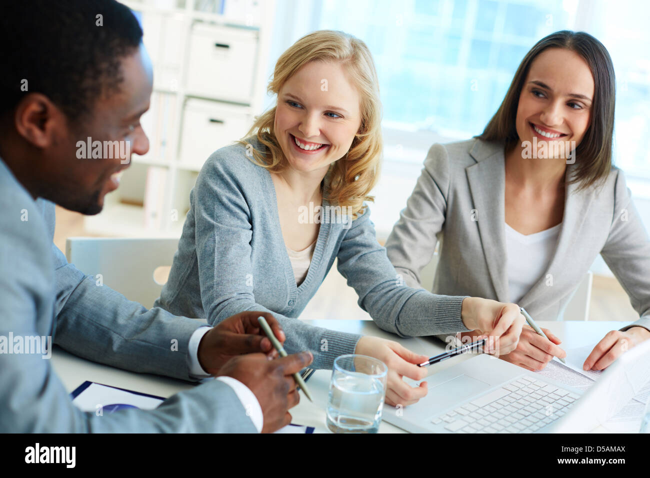 Cheerful business team gathering for a briefing Stock Photo - Alamy