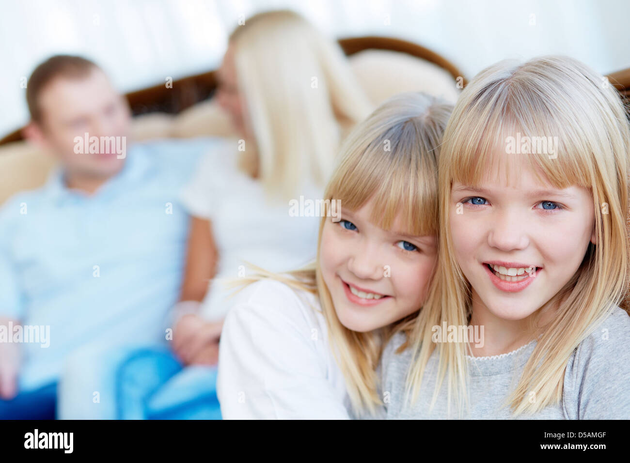 Close-up portrait of affectionate twins with their parents in the ...