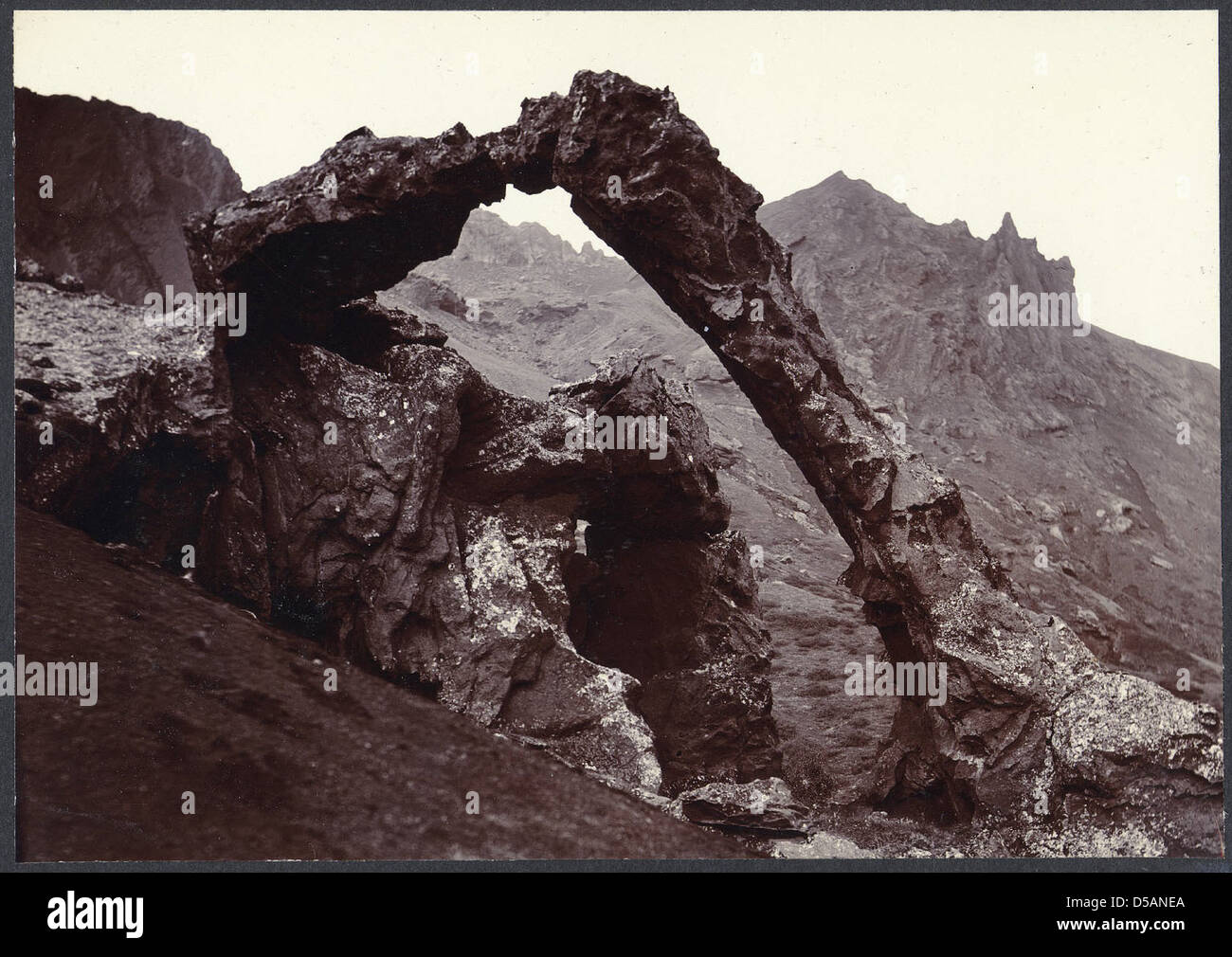 A rock formation featuring natural arches, likely located in Iceland ...