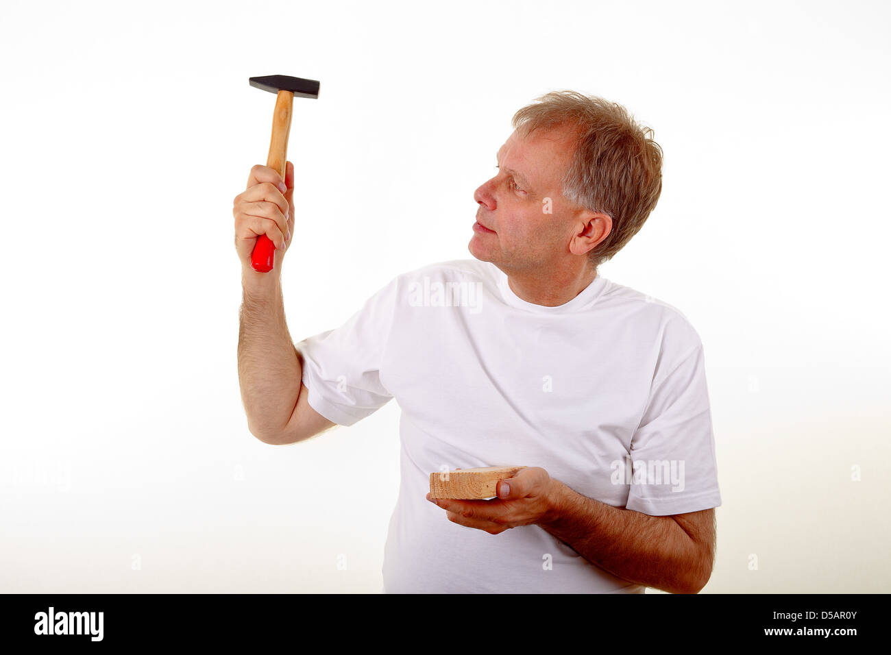 Man hammering nail Stock Photo - Alamy