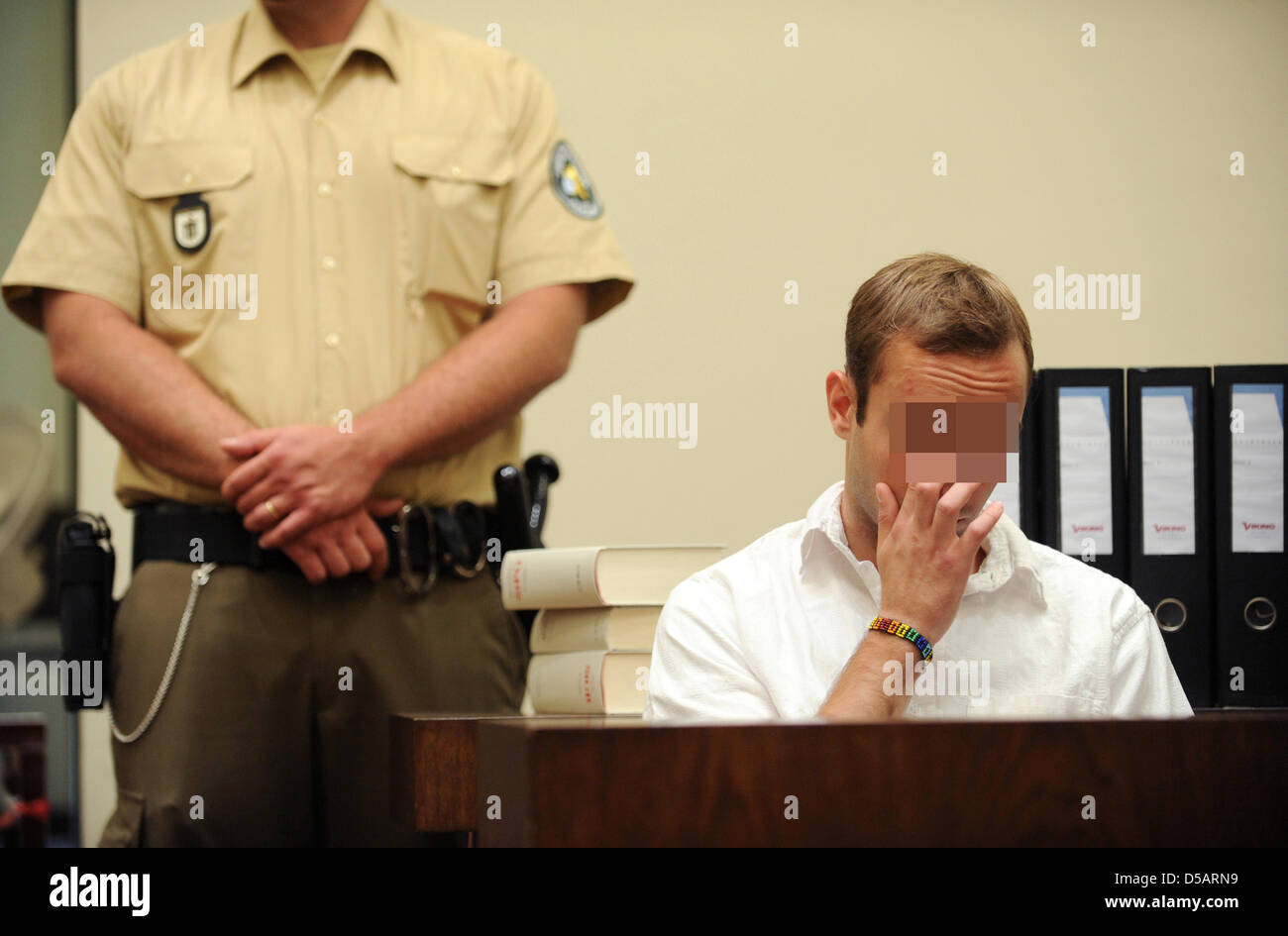 Defendant Sebastian L. sits on the dock at the Regional Court next to a ...
