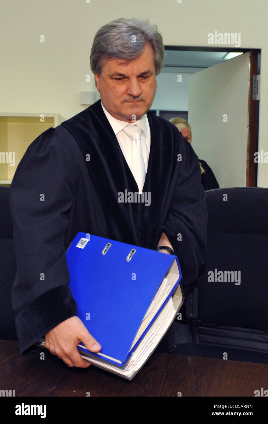 Reinhold Baier (C), chief judge, enters hearing room at the Regional ...