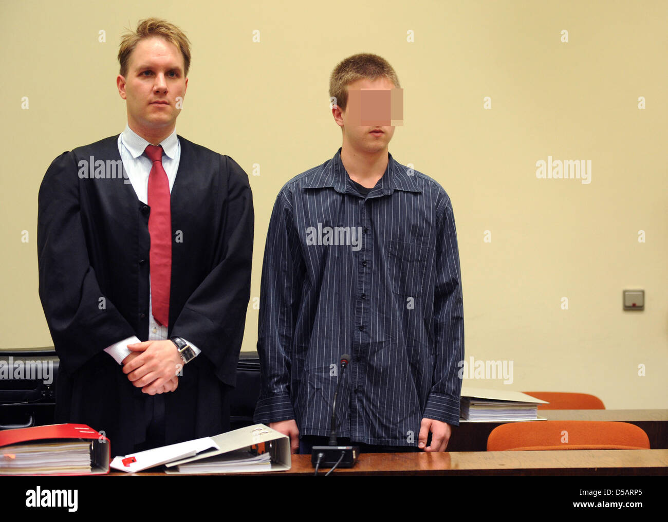 One of the two defendants, Marcus S. (R),stands next to his defense ...