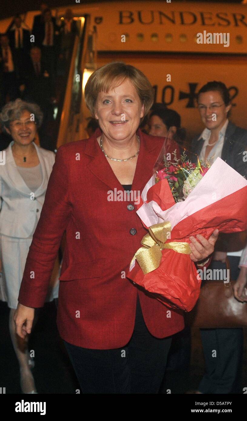 German Chancellor Angela Merkel (C) arrives in Beijing, China, 15 July ...