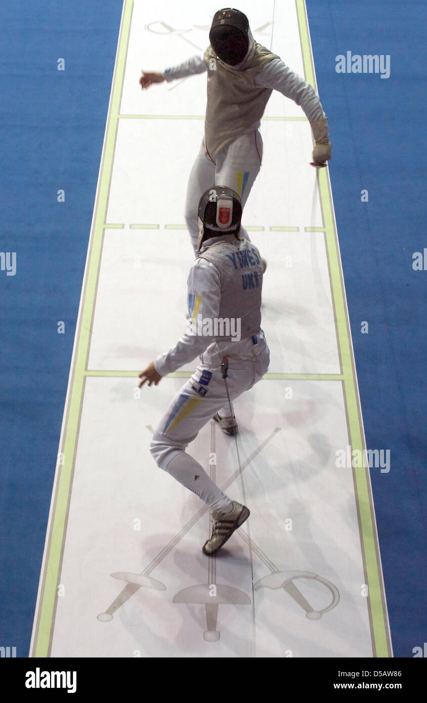 Two fencers duel at the European Fencing Championships 2010 in Leipzig ...