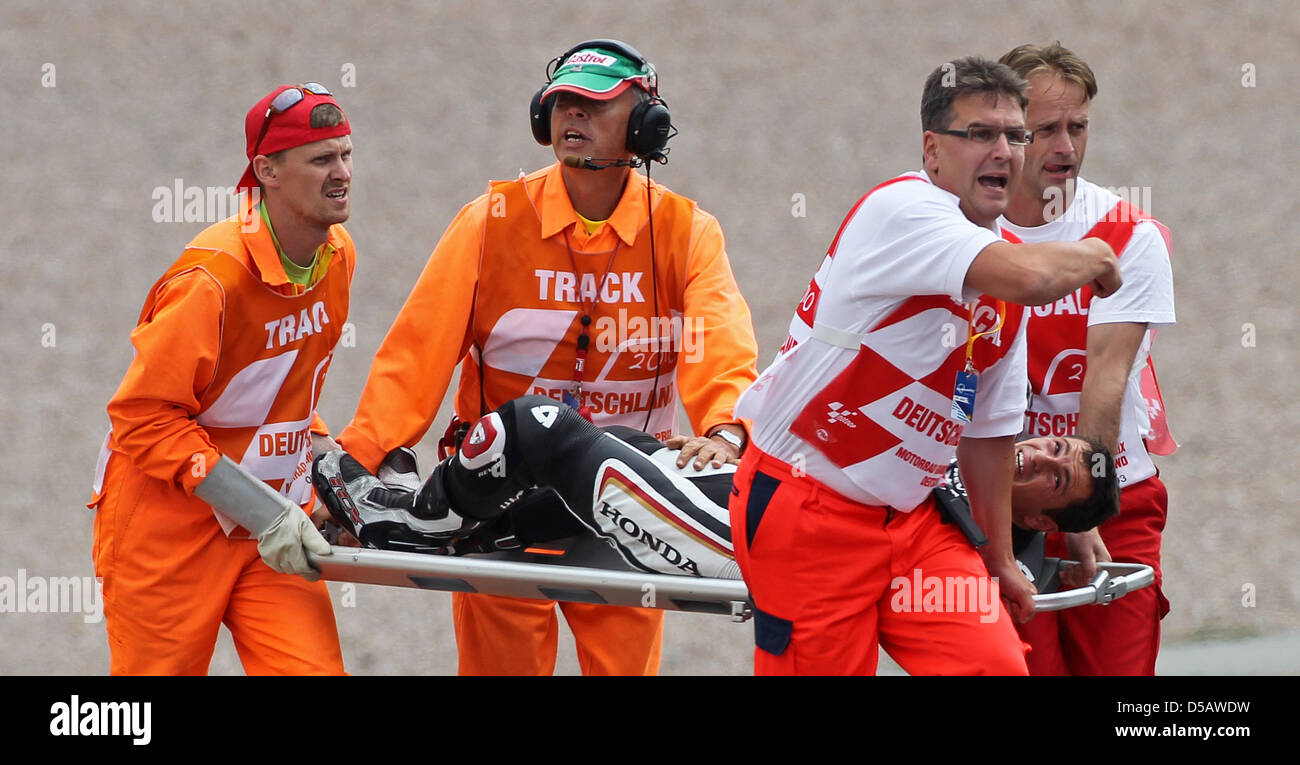 Track marshals recover France's MotoGP rider Randy de Puniet of Honda ...