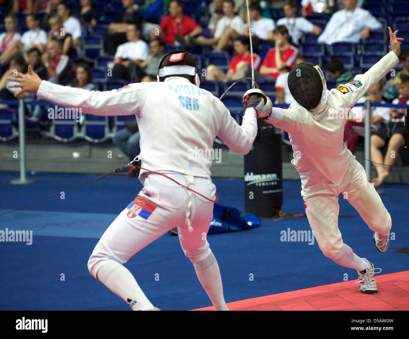 Swiss fencer Max Heinzer (R) leaps forward in the fight with Serbian ...