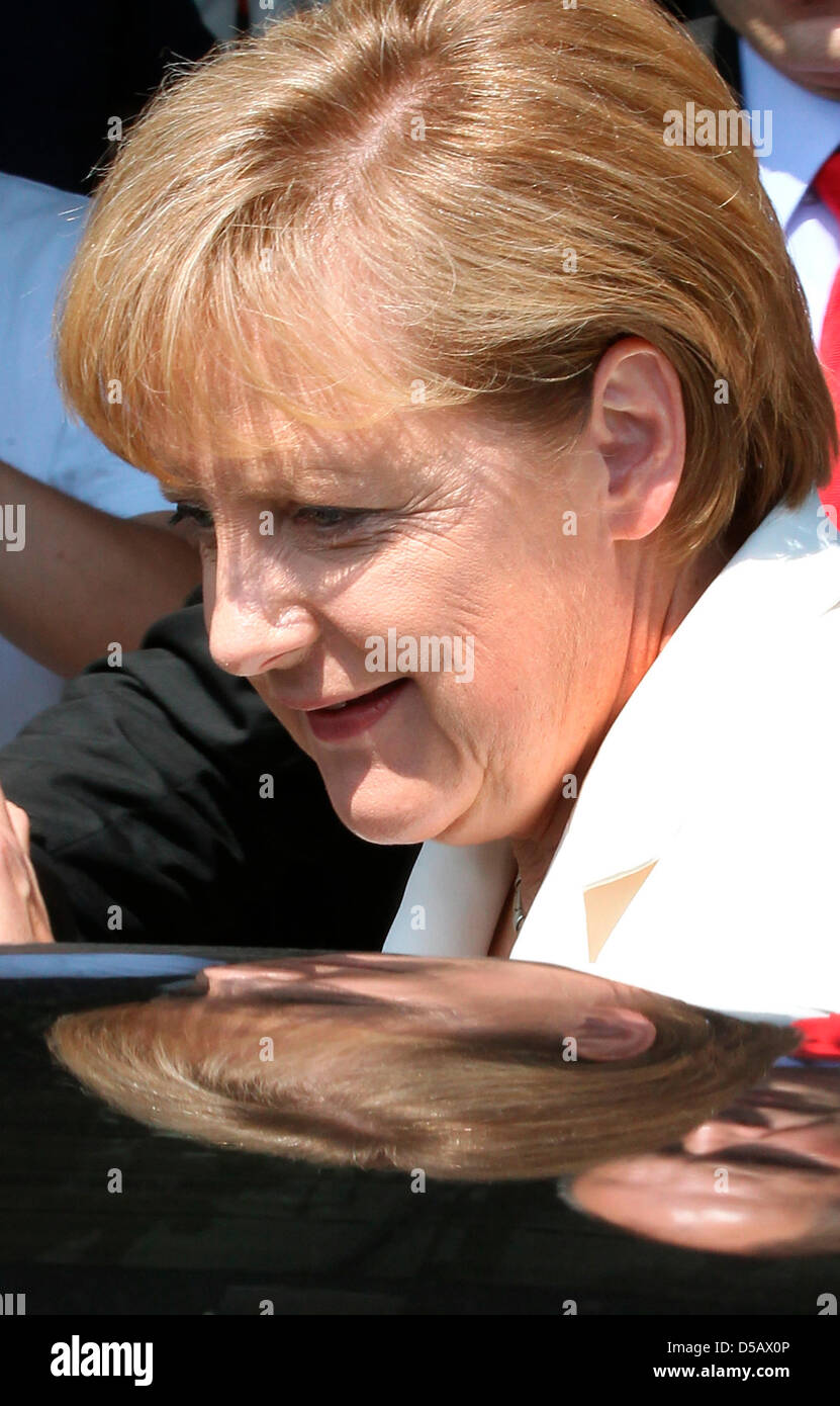 German Chancellor Angela Merkel gets into her official car after ...