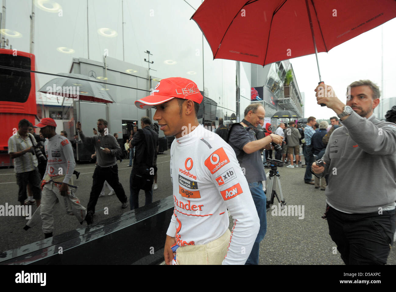 British driver Lewis Hamilton walks through the paddock after the ...