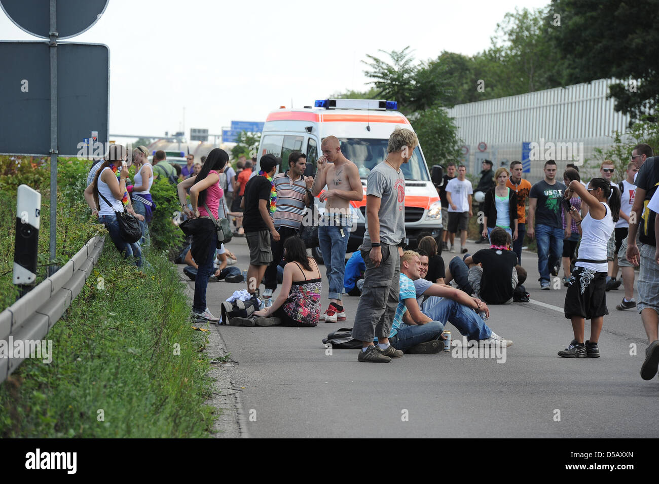 Peple wander across the Autobahn A59 after a mass panic that cost 19 ...