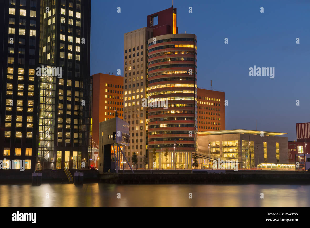 Evening view of illuminated modern office buildings. Rotterdam, The ...