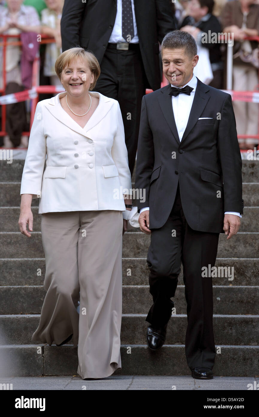 German Chancellor Angela Merkel and her husband Joachim Sauer arrive at ...
