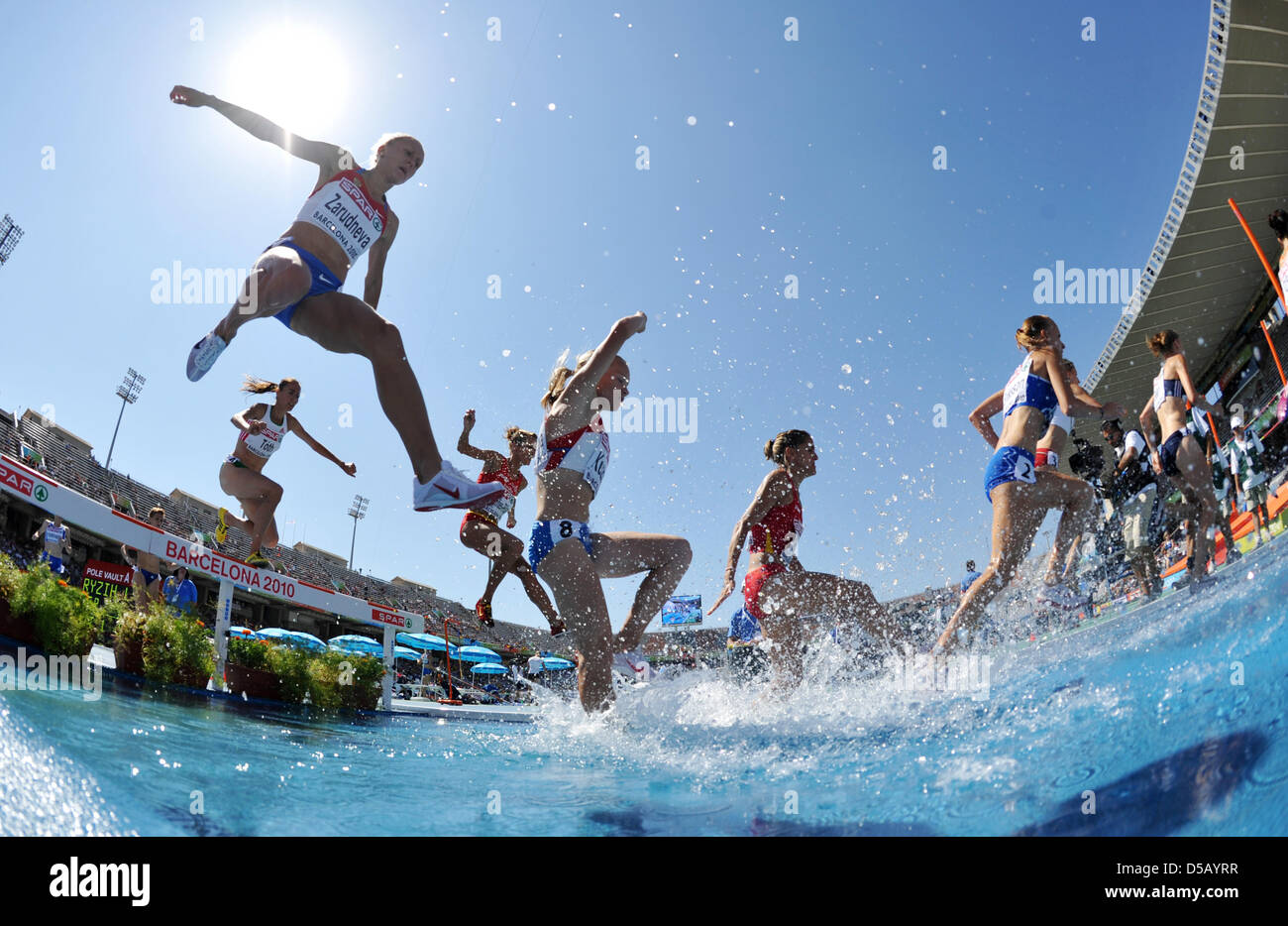 The picture features athletes as they take hurdles followed by a water ...