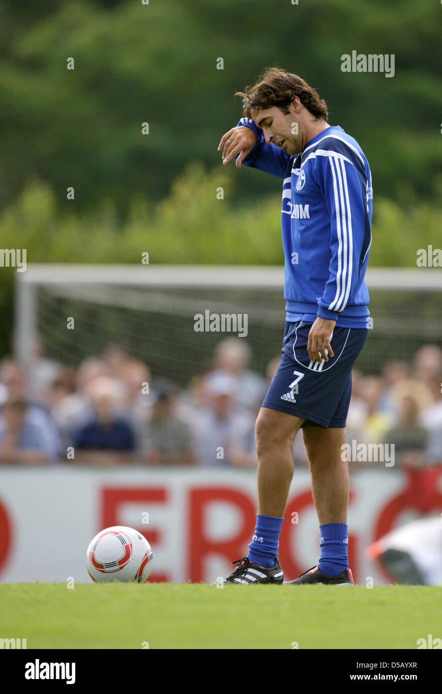 The Spanish soccer player Raul wipes sweat off his face at the first ...