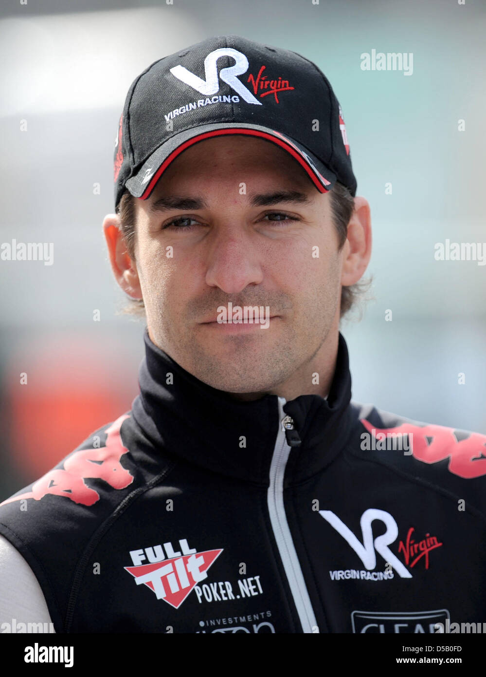 German driver Timo Glock of Virgin Racing walks through the pit lane ...