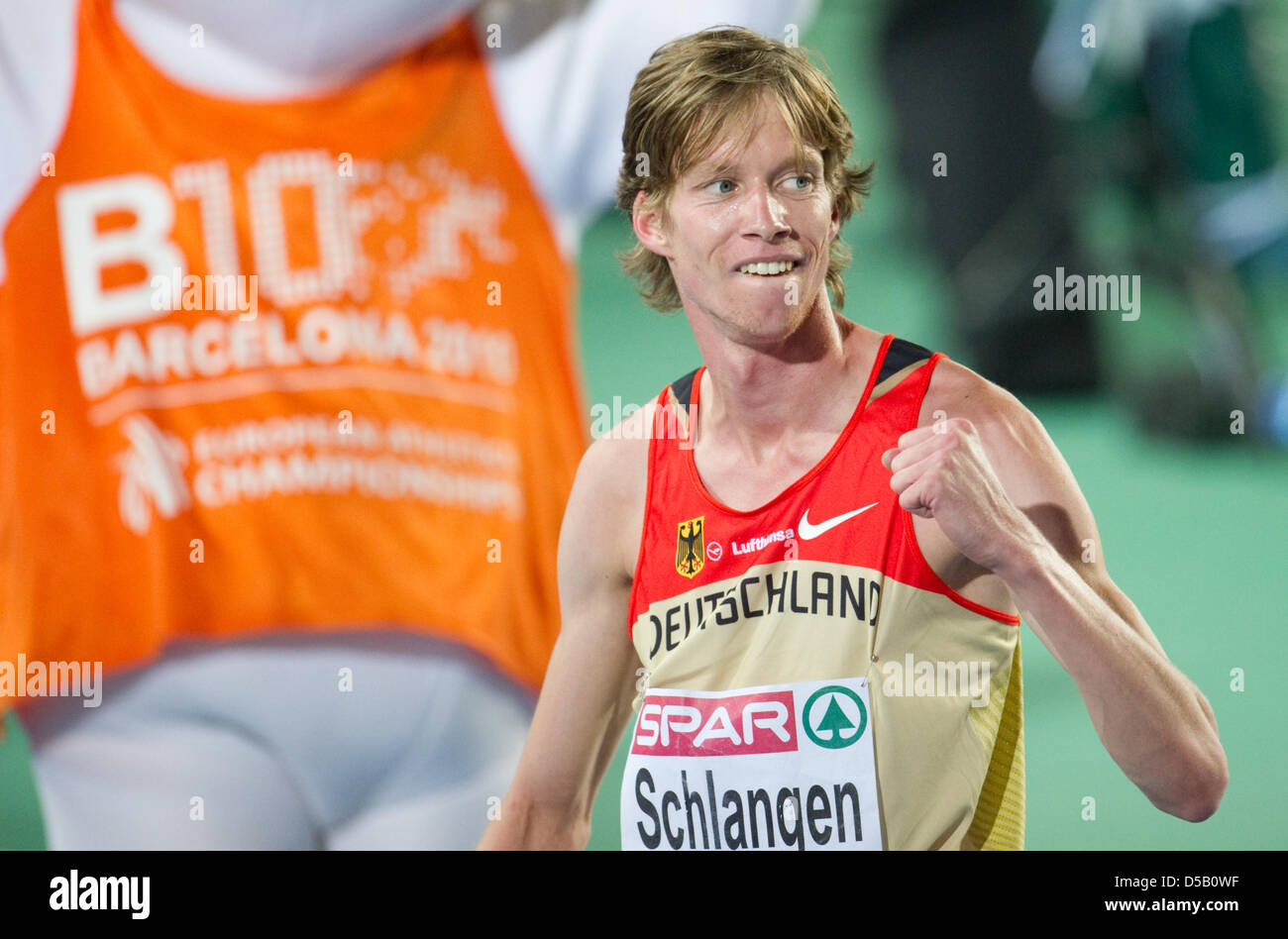 German runner Carsten Schlangen celebrates his second place in the ...