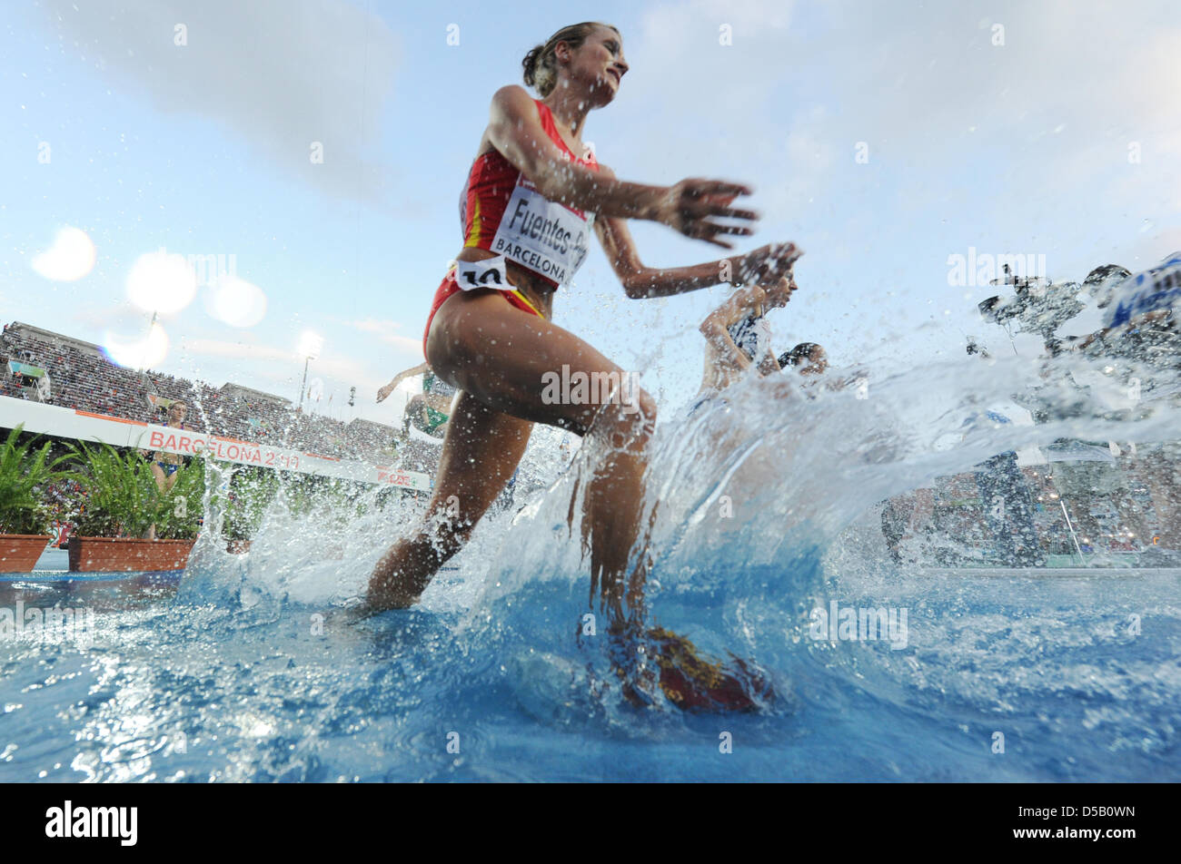 Runners pass over obstacles in the 3,000 metres steeplechase women's ...