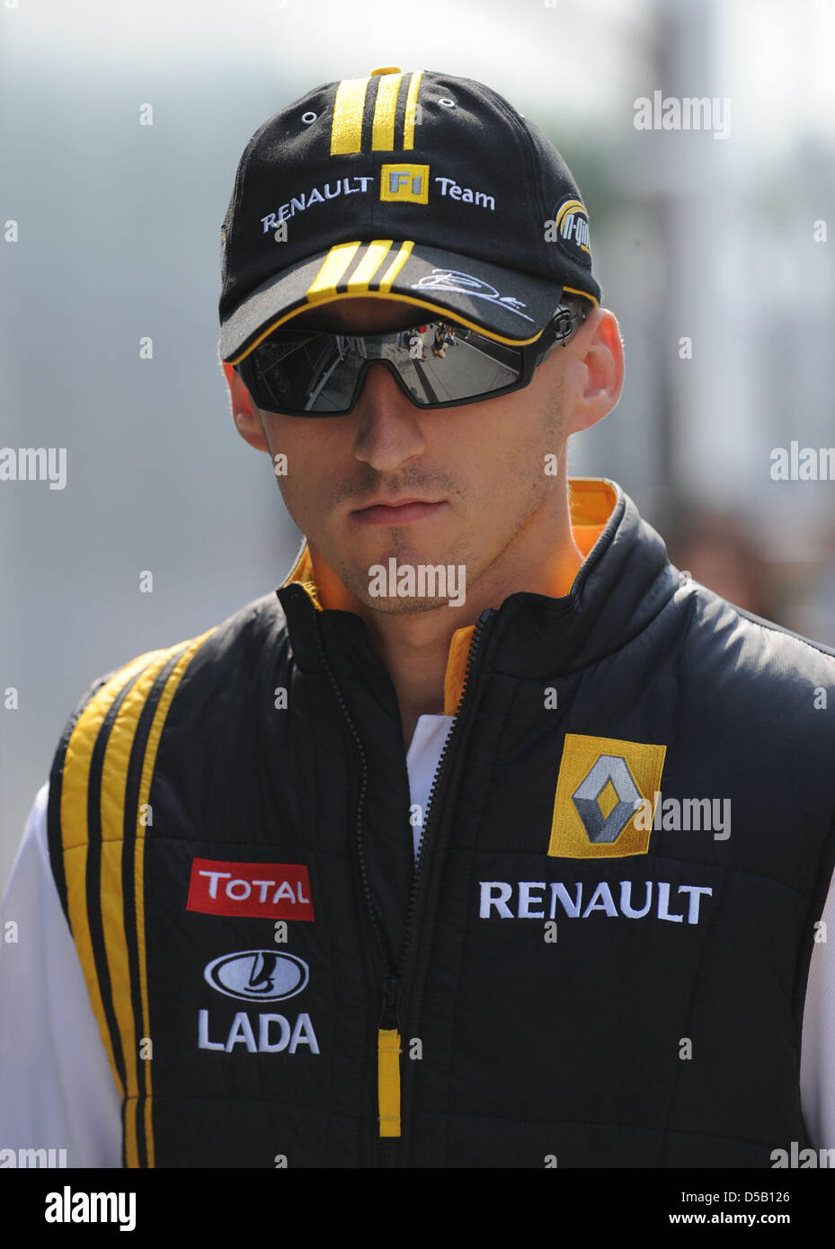 Polish race driver Robert Kubica of Renault of Team Red Bull walks ...