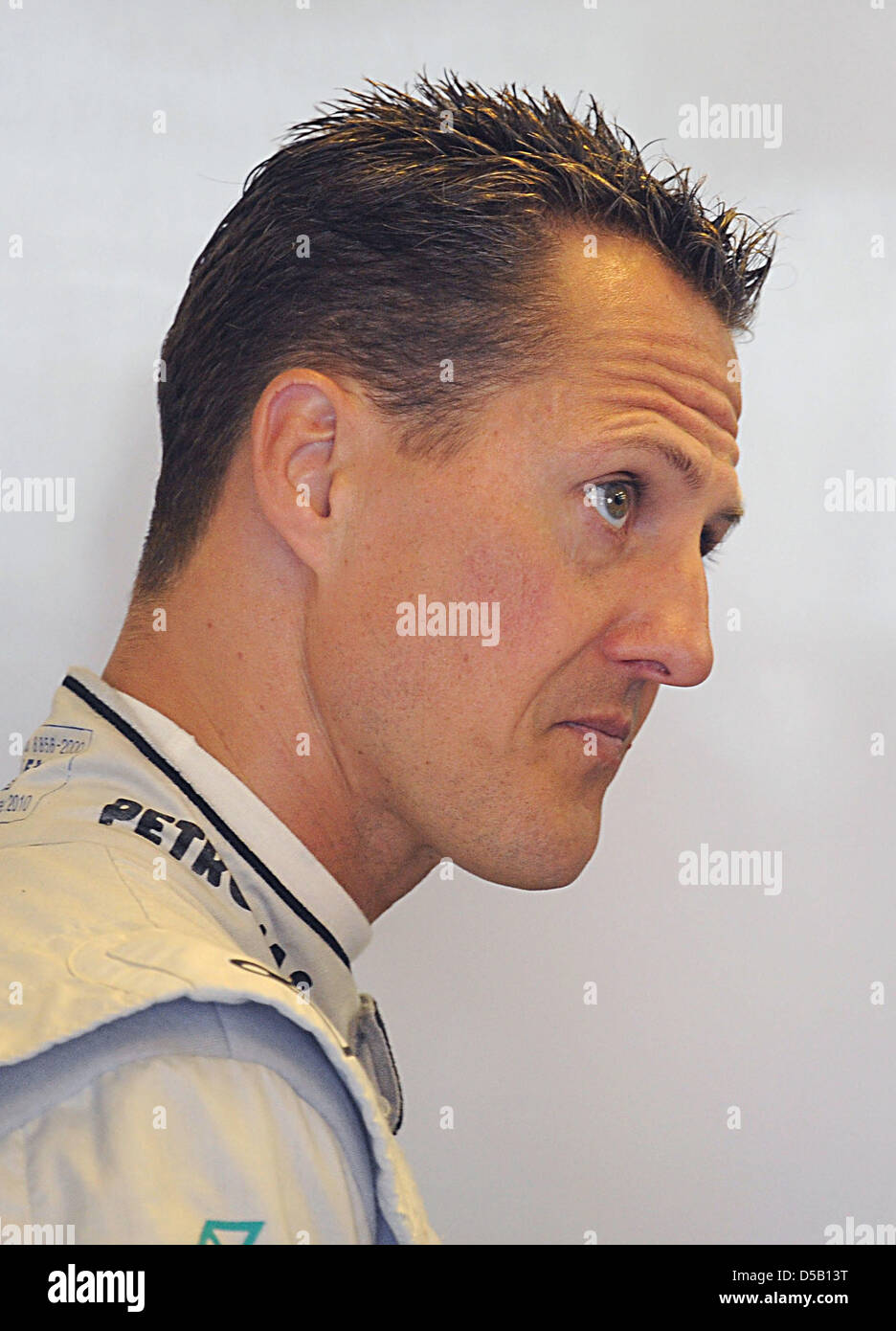 German race driver Michael Schumacher of Mercedes GP stands in his box ...