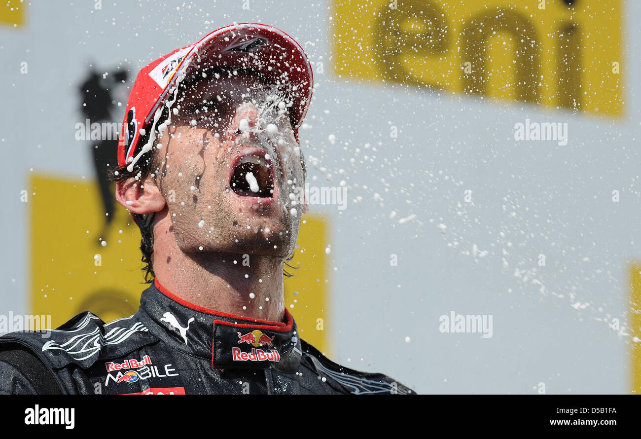 The Australian driver Mark Webber from Red Bull stands on the podium ...