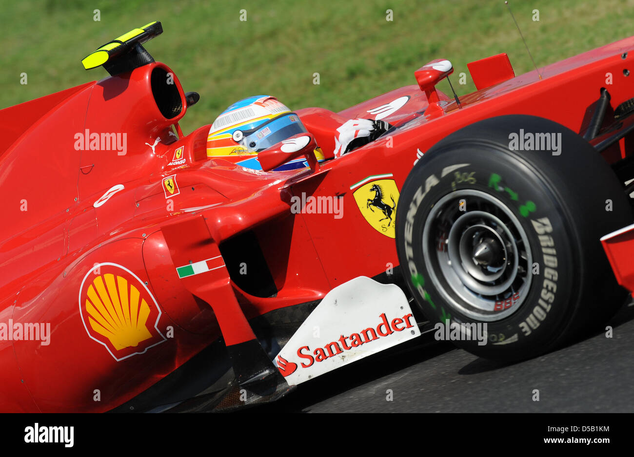 Spanish driver Fernando Alonso of Ferrari drives through a turn during ...