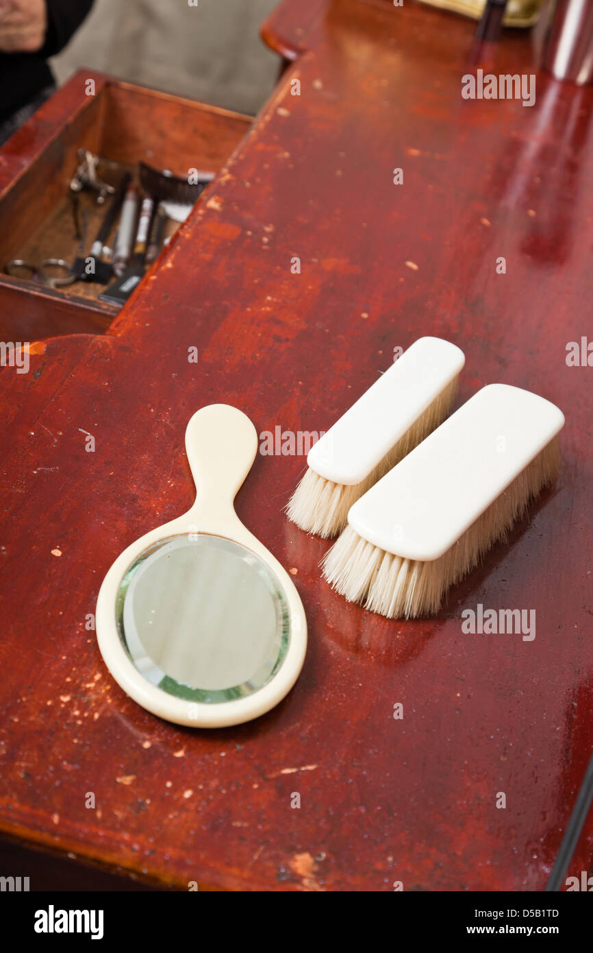 Antique mirror with two brushes on old wooden make-up table Stock Photo ...