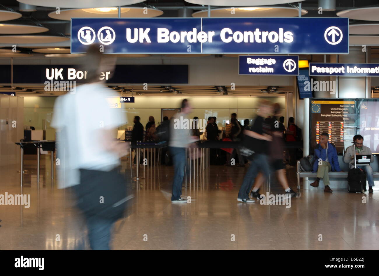 Voyagers enter the pass control area at Heathrow Airport Terminal 5 in ...