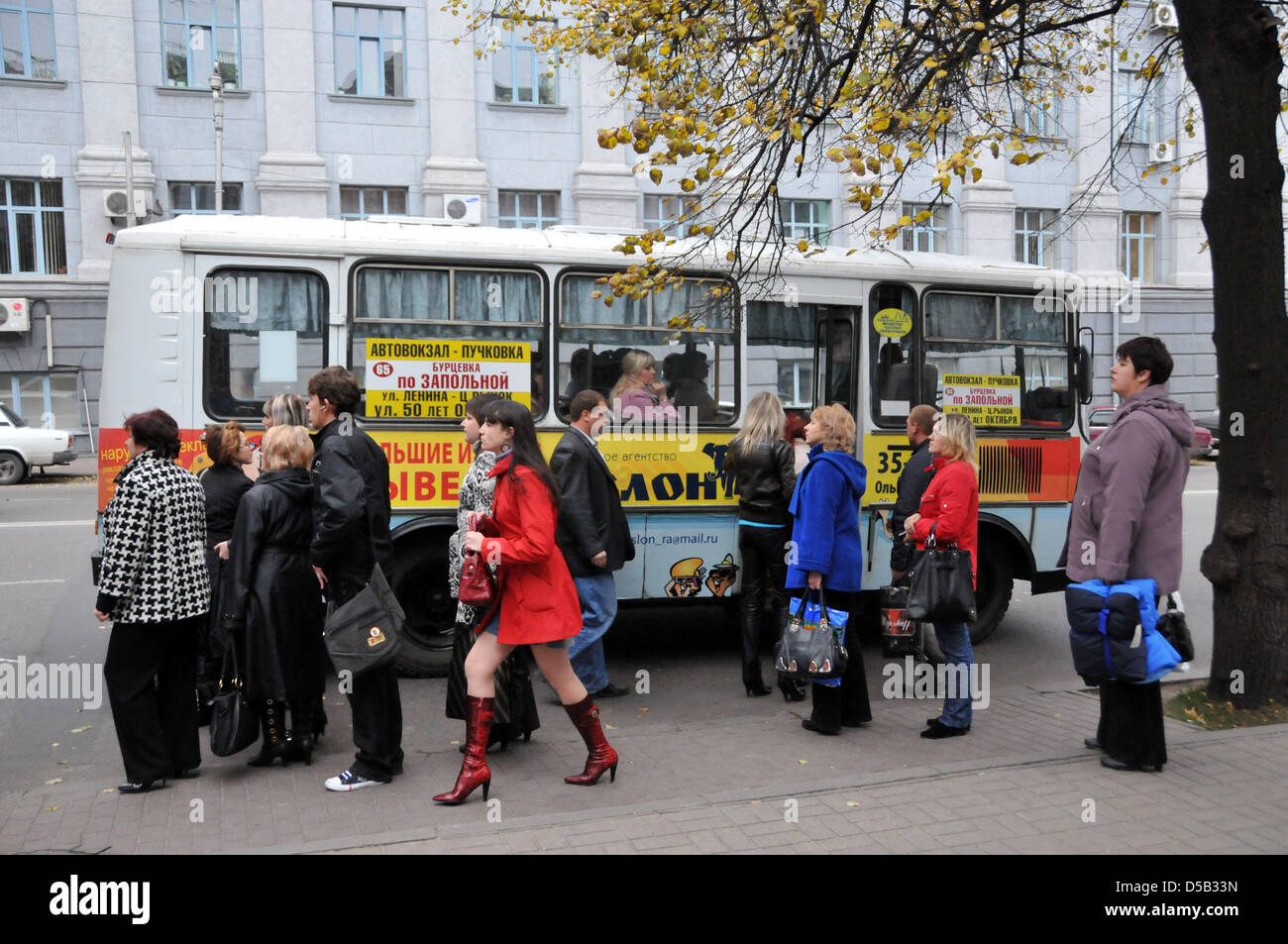 People wait at a bus stop near the Hall of Heroes in Kursk, Russia, 16 ...