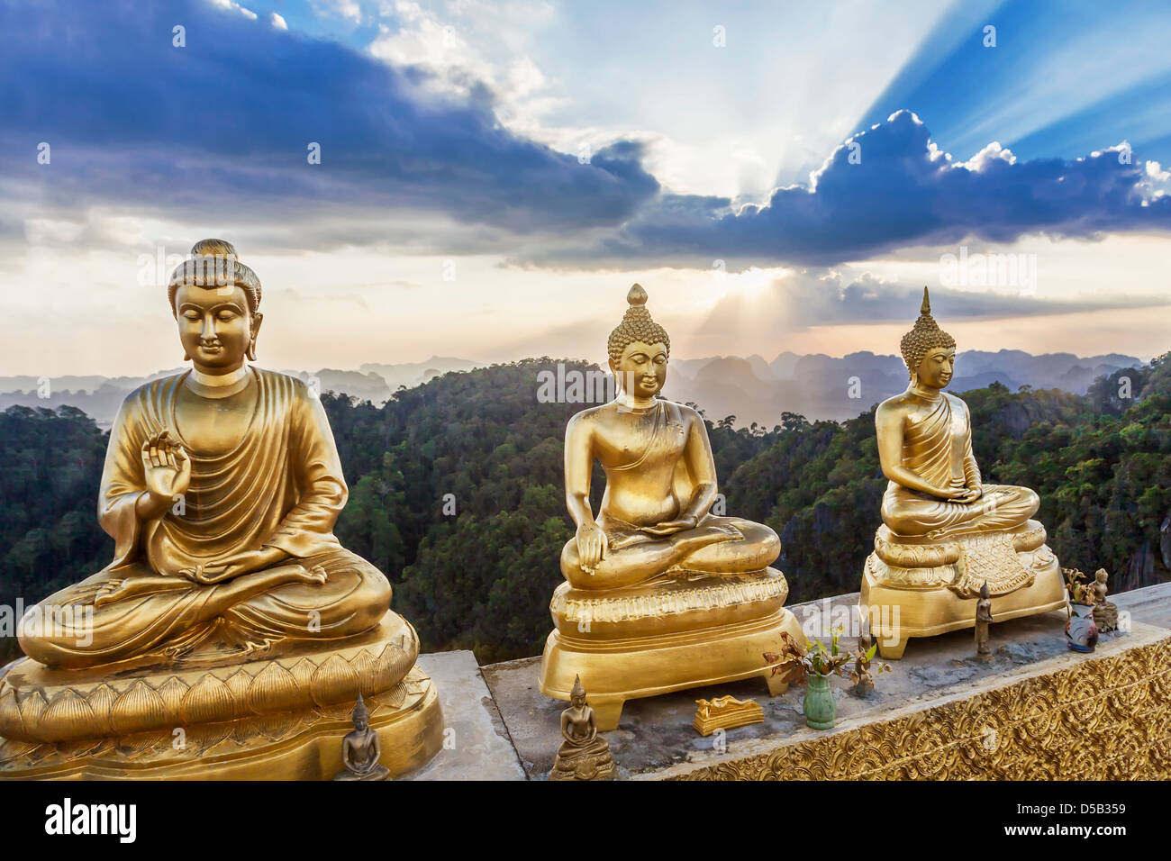 Buddha statues with beauty sunset background Stock Photo - Alamy