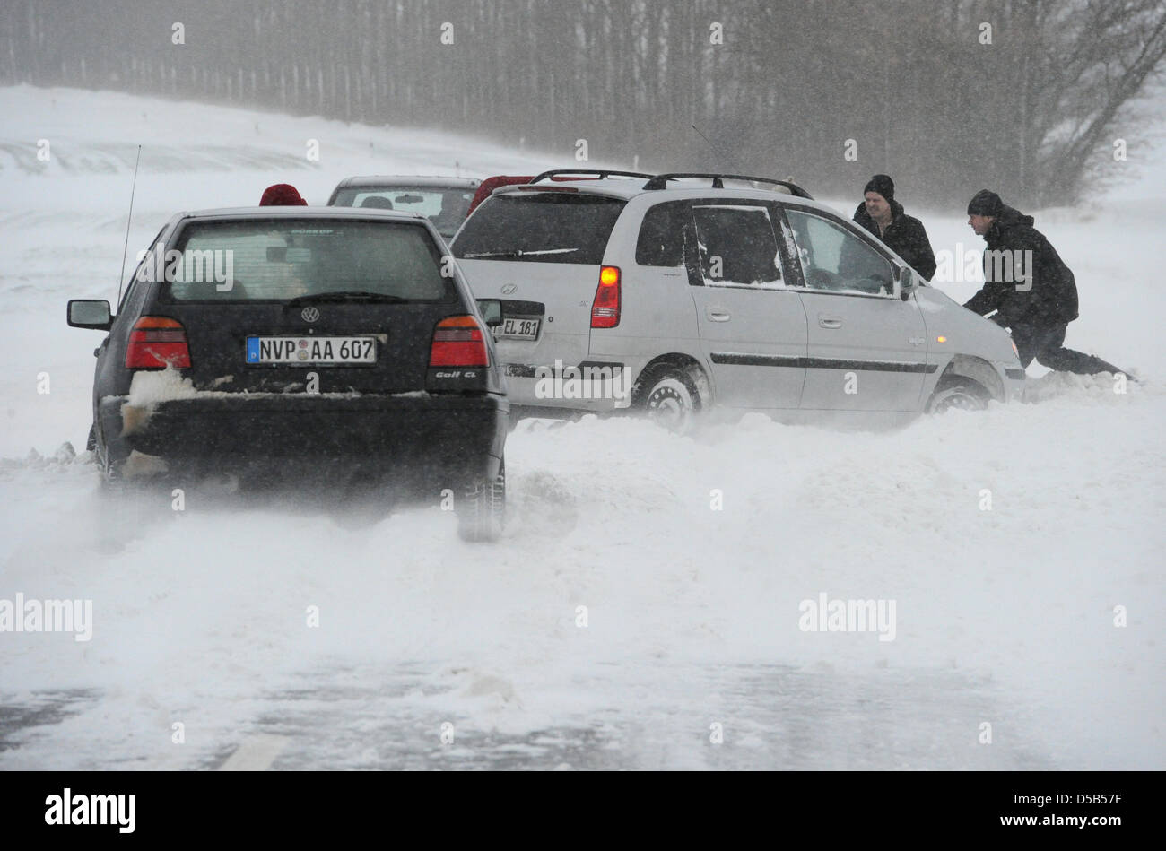 Motorist try to get their cars out of the snow on the road L30 at ...