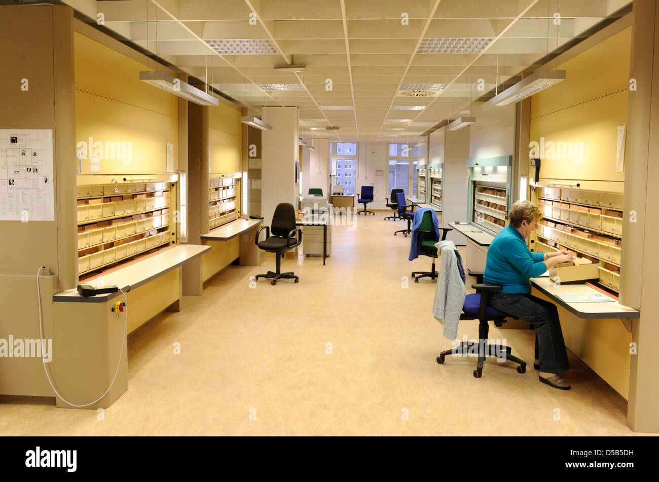 A member staff checks files at the at the so called 'Stasi ...