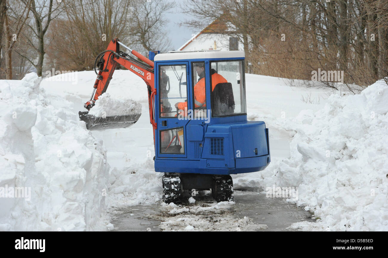 A shovel dozer works his way through the snow towards the village Banz ...