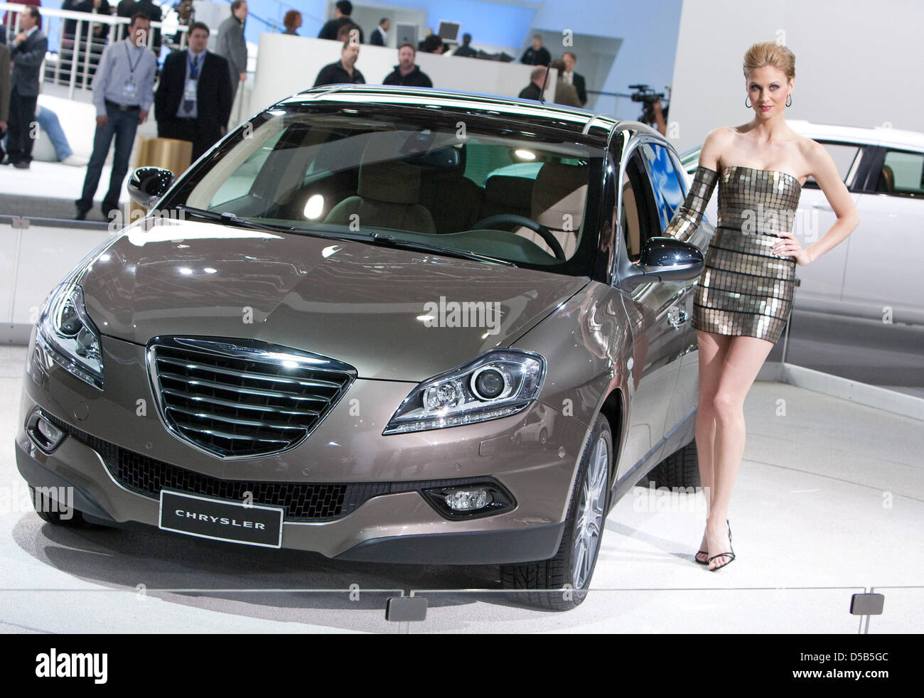 A model poses next to a Chrysler on display at the North American ...