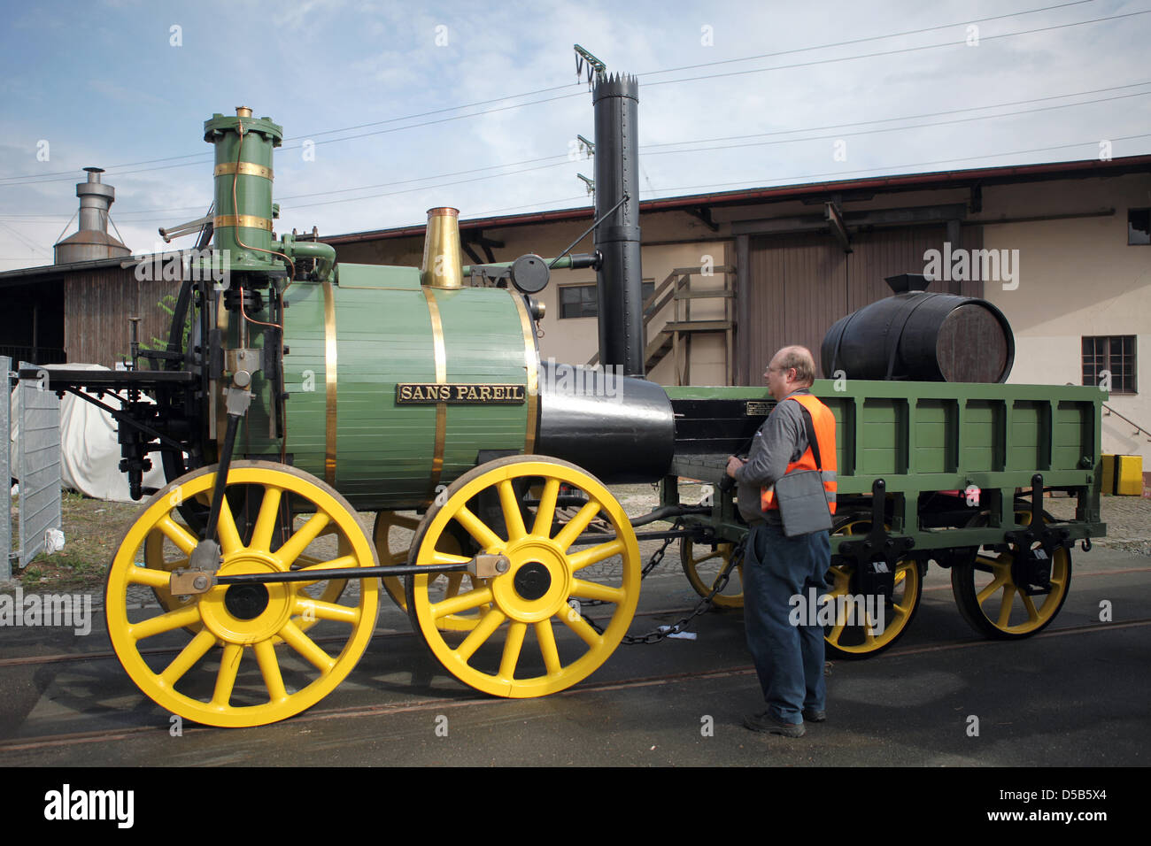 The picture features a reproduction of the historical steam locomotive ...