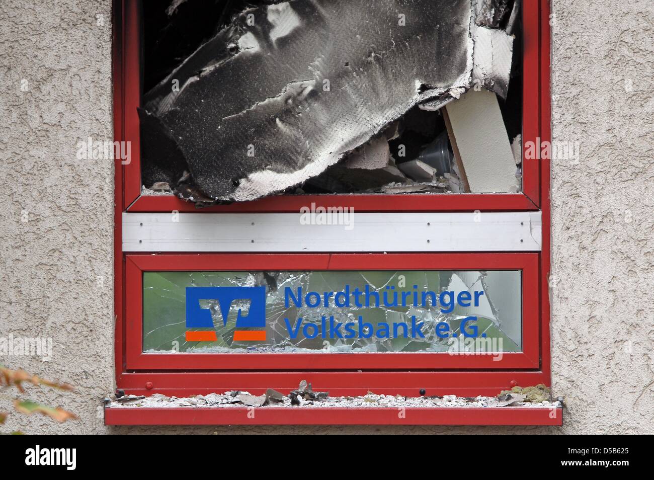 Rubble and debris can be seen behind a blown-out window after a ...