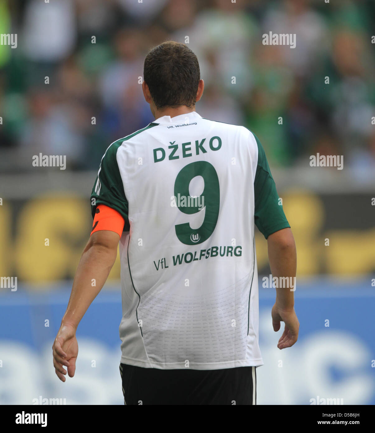 Wolfsburg striker and team captain Edin Dzeko walks across the pitch ...