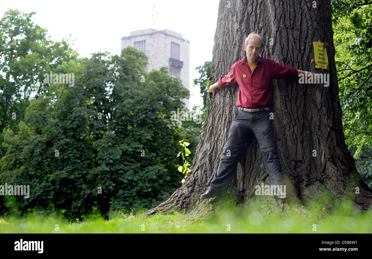 Klaus Gebhard hugs a tree at the Schlosspark in Stuttgart, Germany, 04 ...
