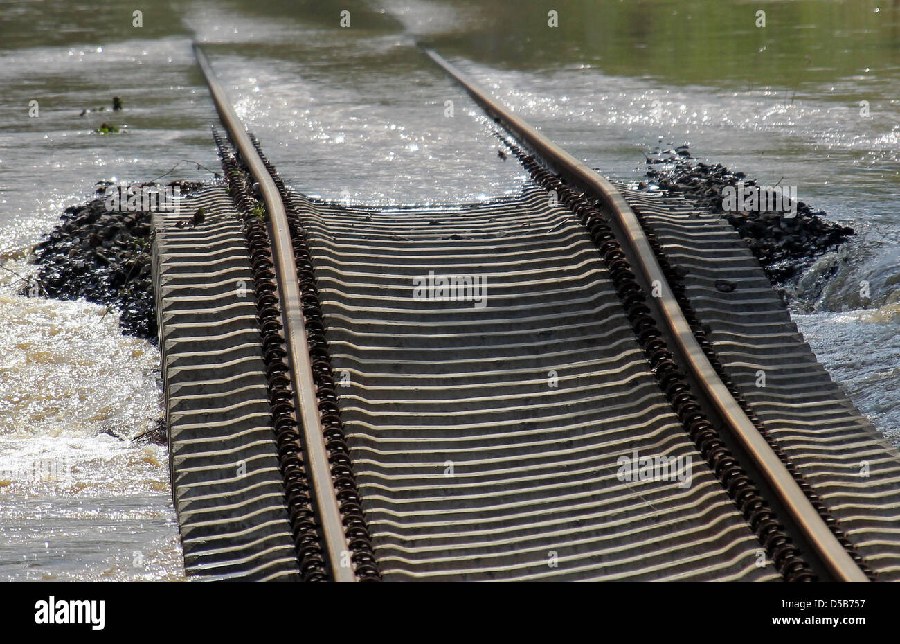 Railway tracks bend after they have been washed out by high water in ...