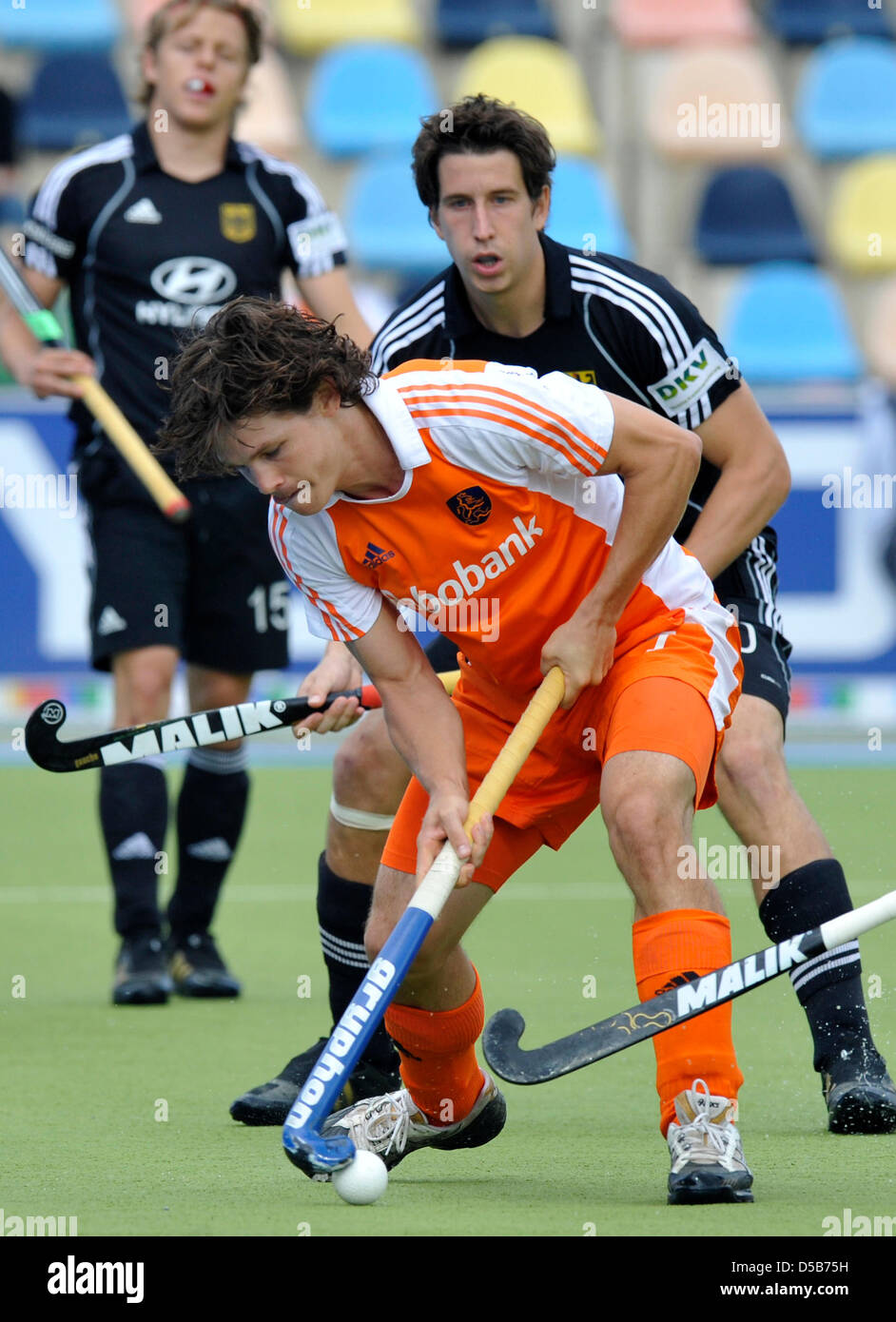 The Netherland's Wouter Jolie (front) gets to teh ball before Germany's ...