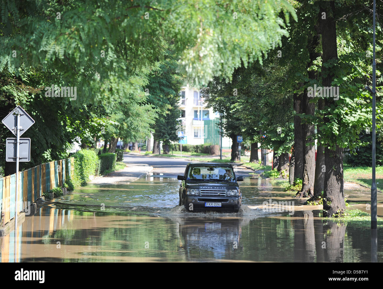 A car drives down the Roosevelt Street that is flooded by the high ...