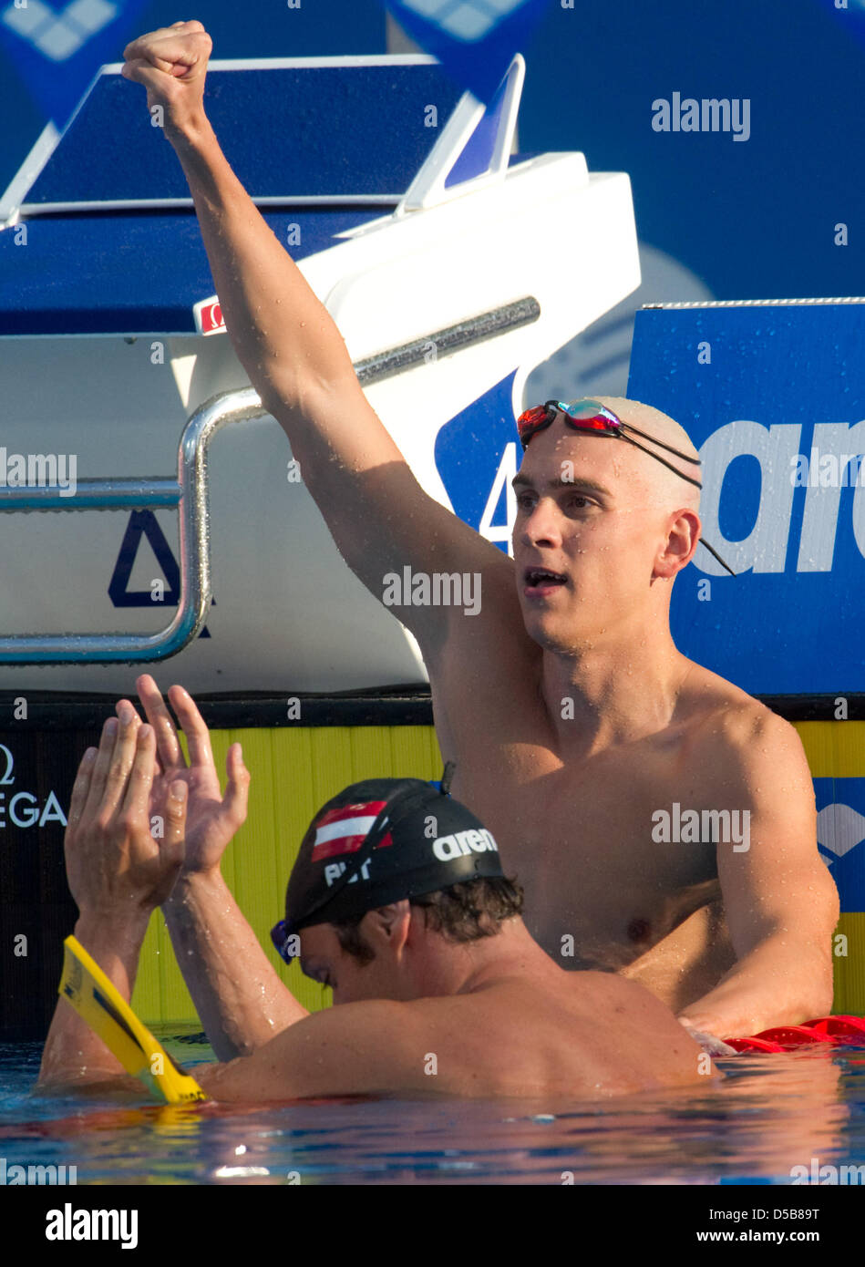 Hungarian swimmer Laszlo Cseh (top) cheers after winning in the men's ...