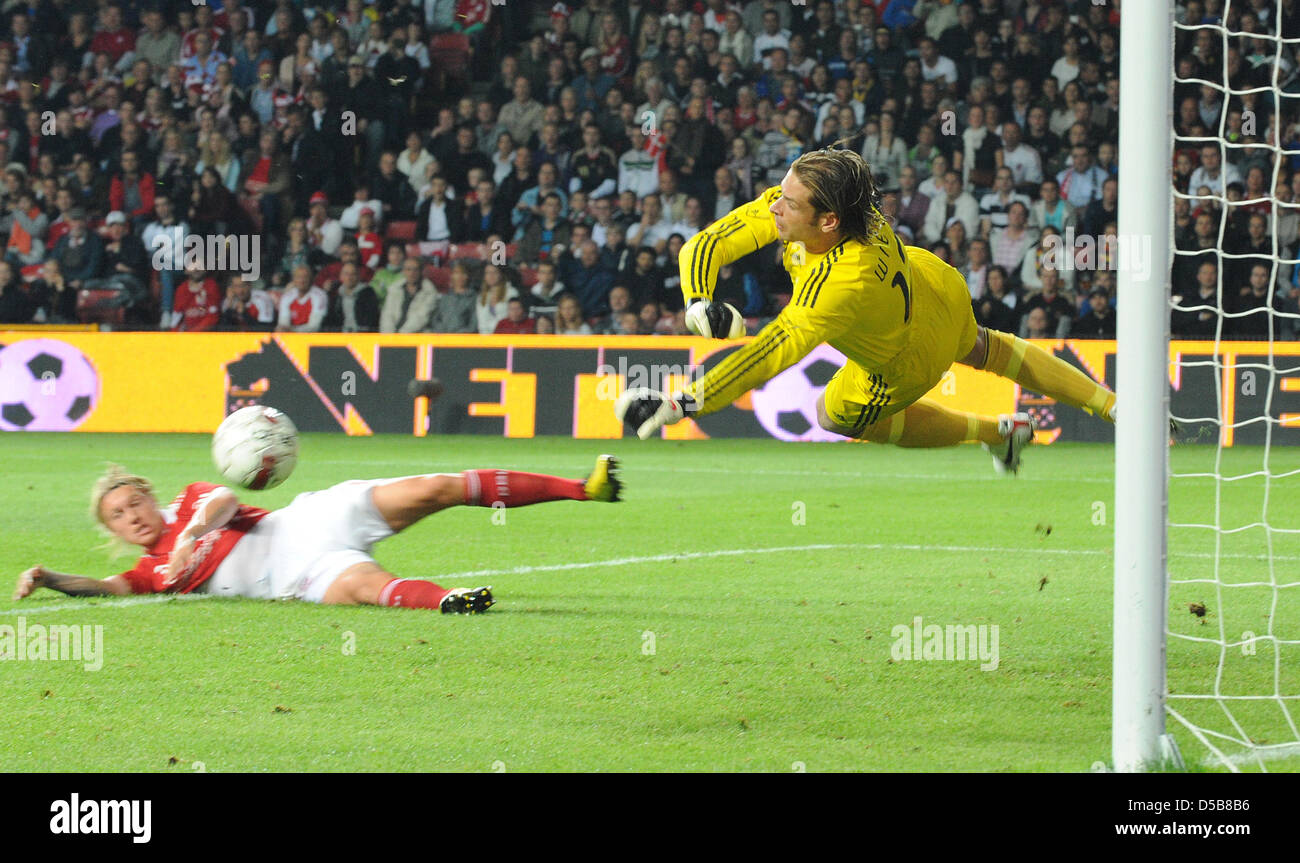 Germany's goalkeeper Tim Wiese (R) fights off a shot from the Danish ...