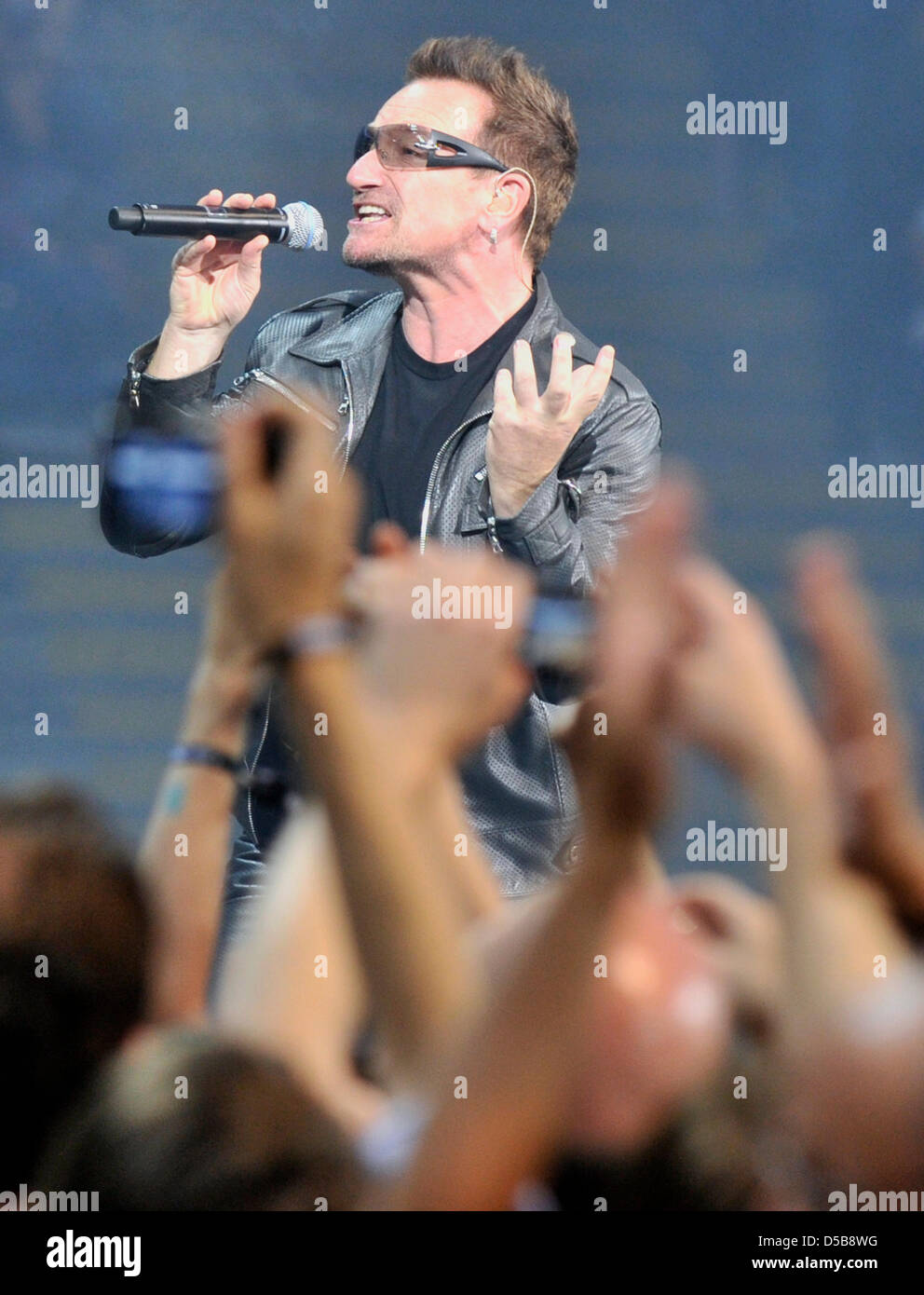 Frontman Bono, of the Irish band U2, sings for 55.000 fans in the ...