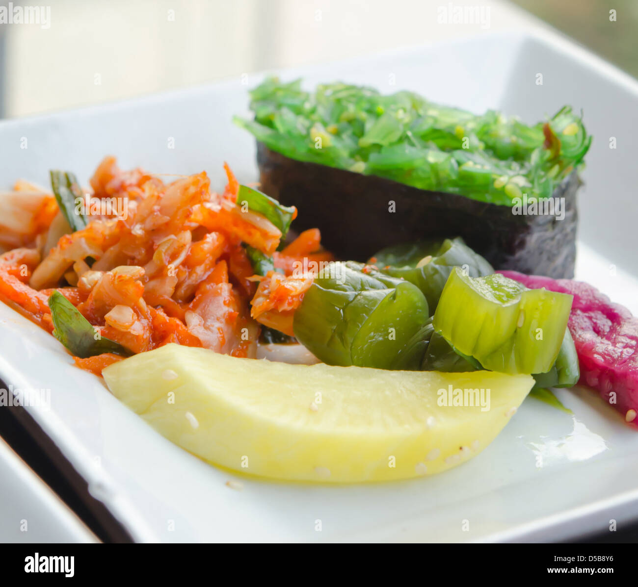 kimchi and pickled vegetable , Chuka seaweed sush on white plate Stock ...