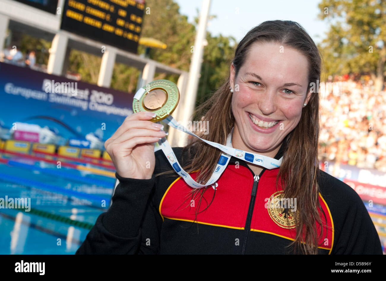 German swimmer Jenny Mensing poses with her medal in her hand and ...
