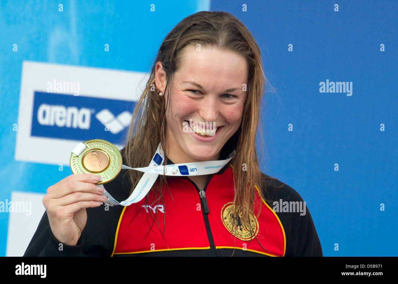 German swimmer Jenny Mensing poses with her medal in her hand and ...