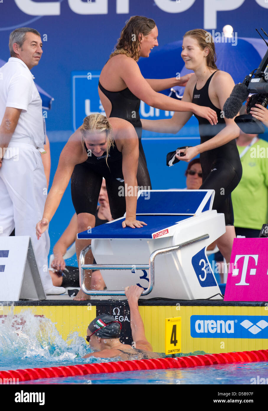 The athletes of the Hungarian relay swimming team cheer after winning ...