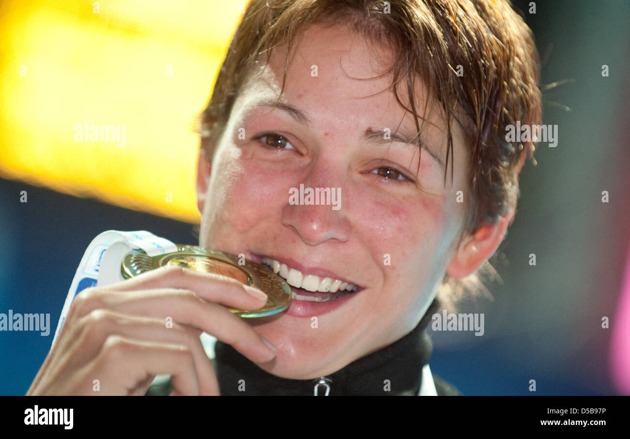 German diver Christin Steuer bites her medal following her victory in ...