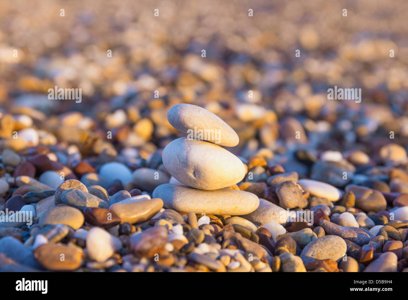 three beach-stone pyramid in the morning sun Stock Photo - Alamy