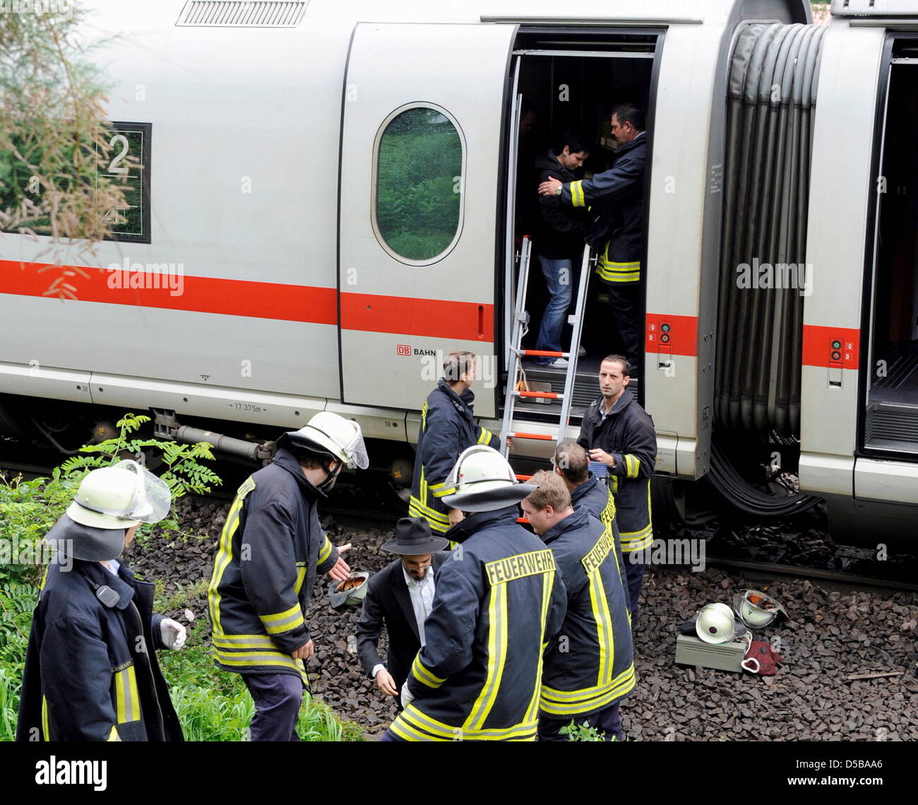 Fire fighters help people exit an ICE high speed train after a refuse ...